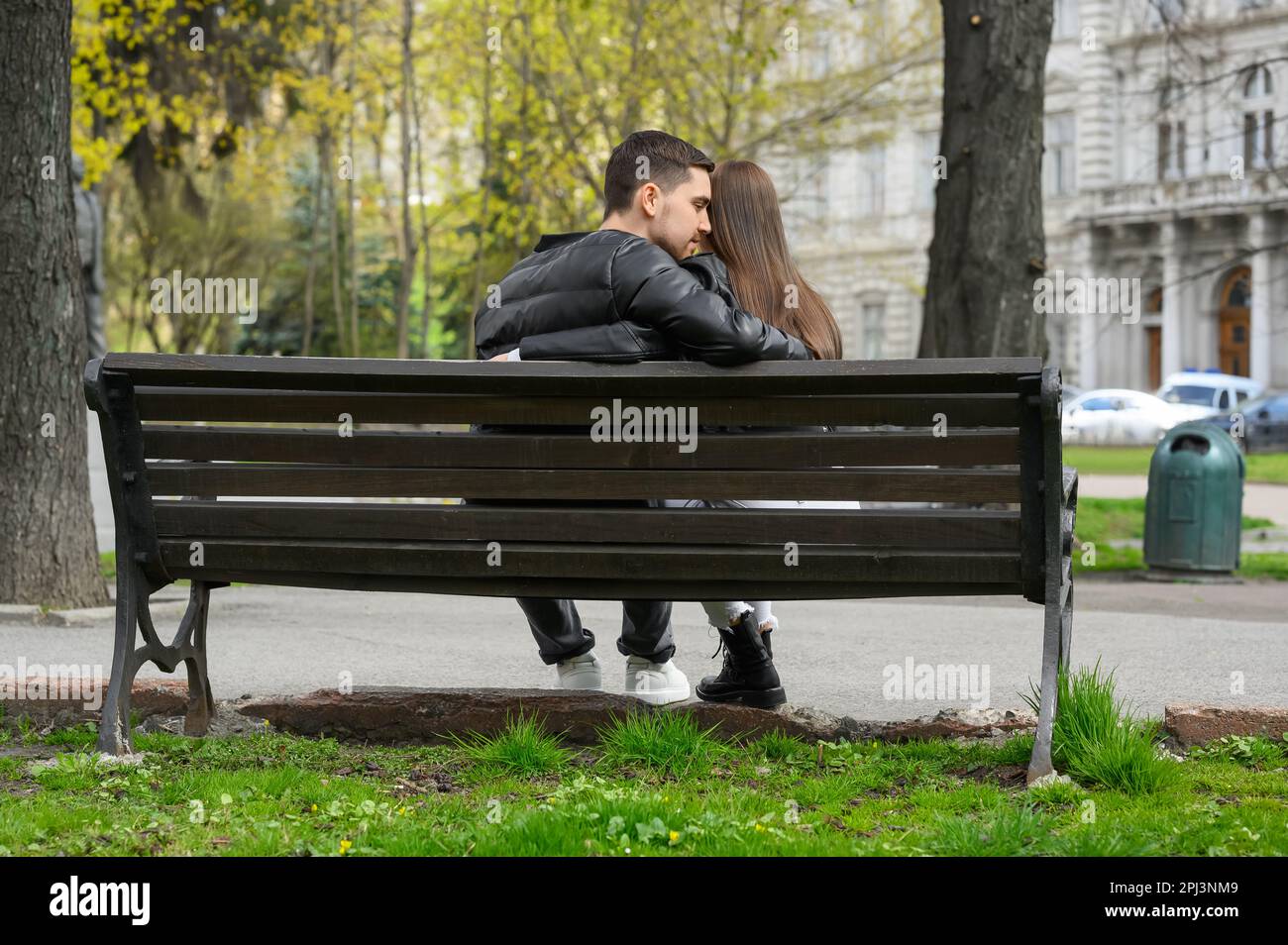 Lovely young couple on bench outdoors, back view. Romantic date Stock ...
