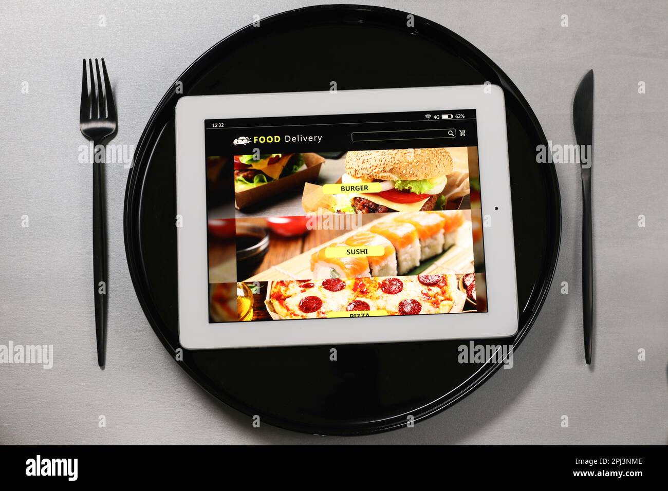 Modern tablet with open page for online food ordering, plate and ...