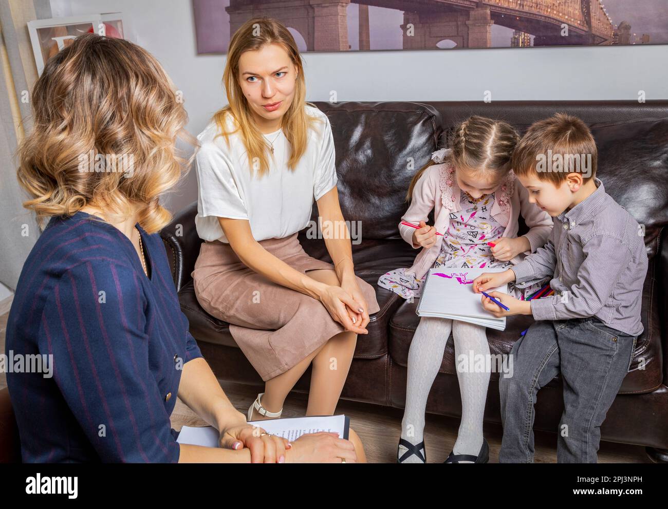 Mother with children at the reception of a psychologist, asking for ...