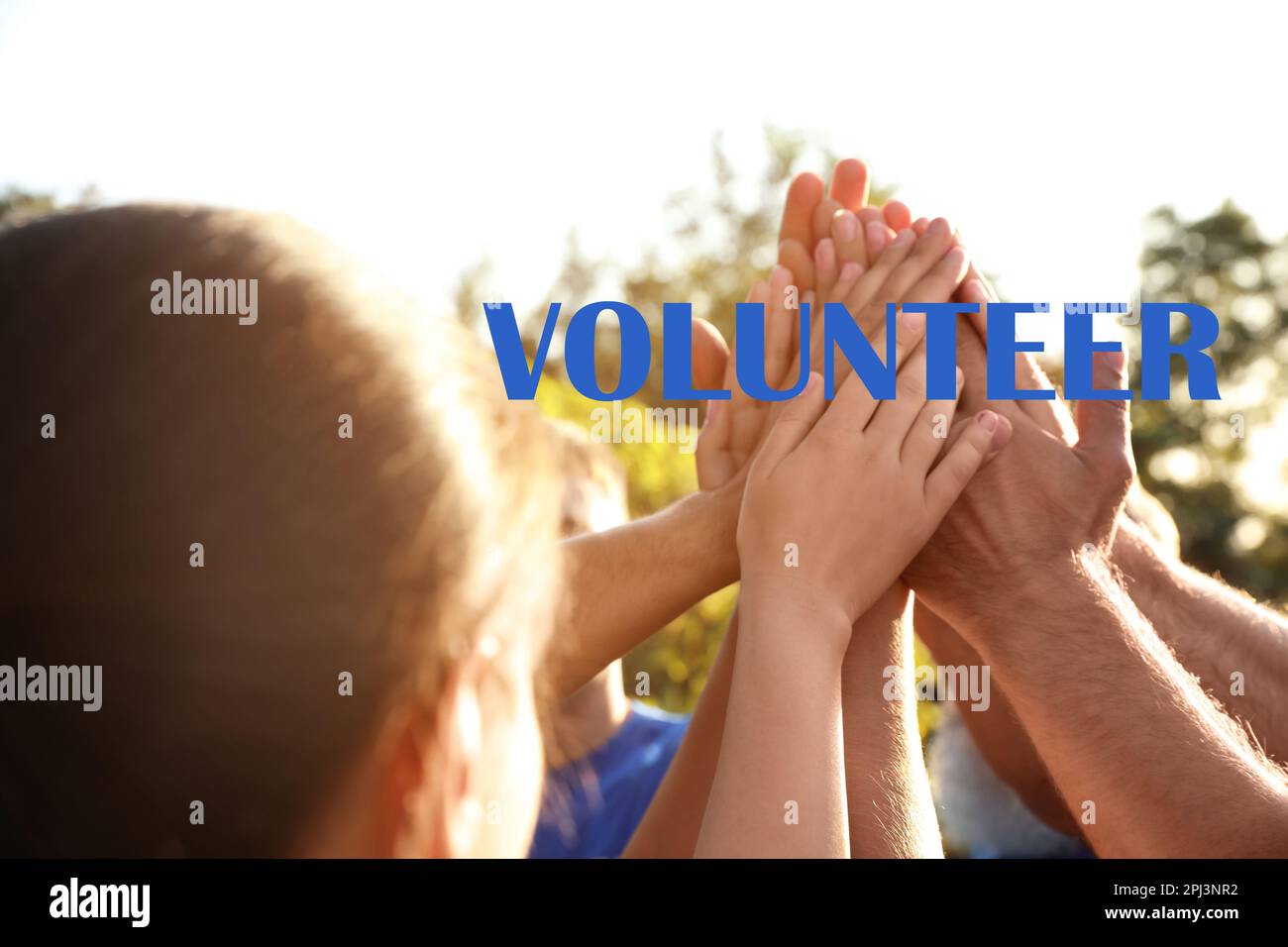 Group of volunteers putting hands together outdoors, closeup Stock ...