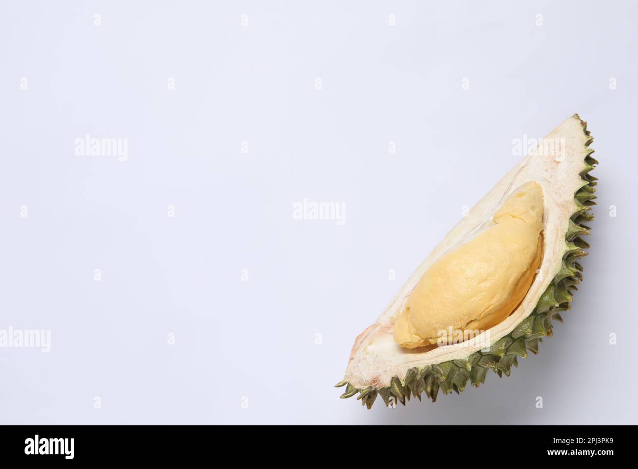 Piece of fresh ripe durian on white background, top view. Space for ...