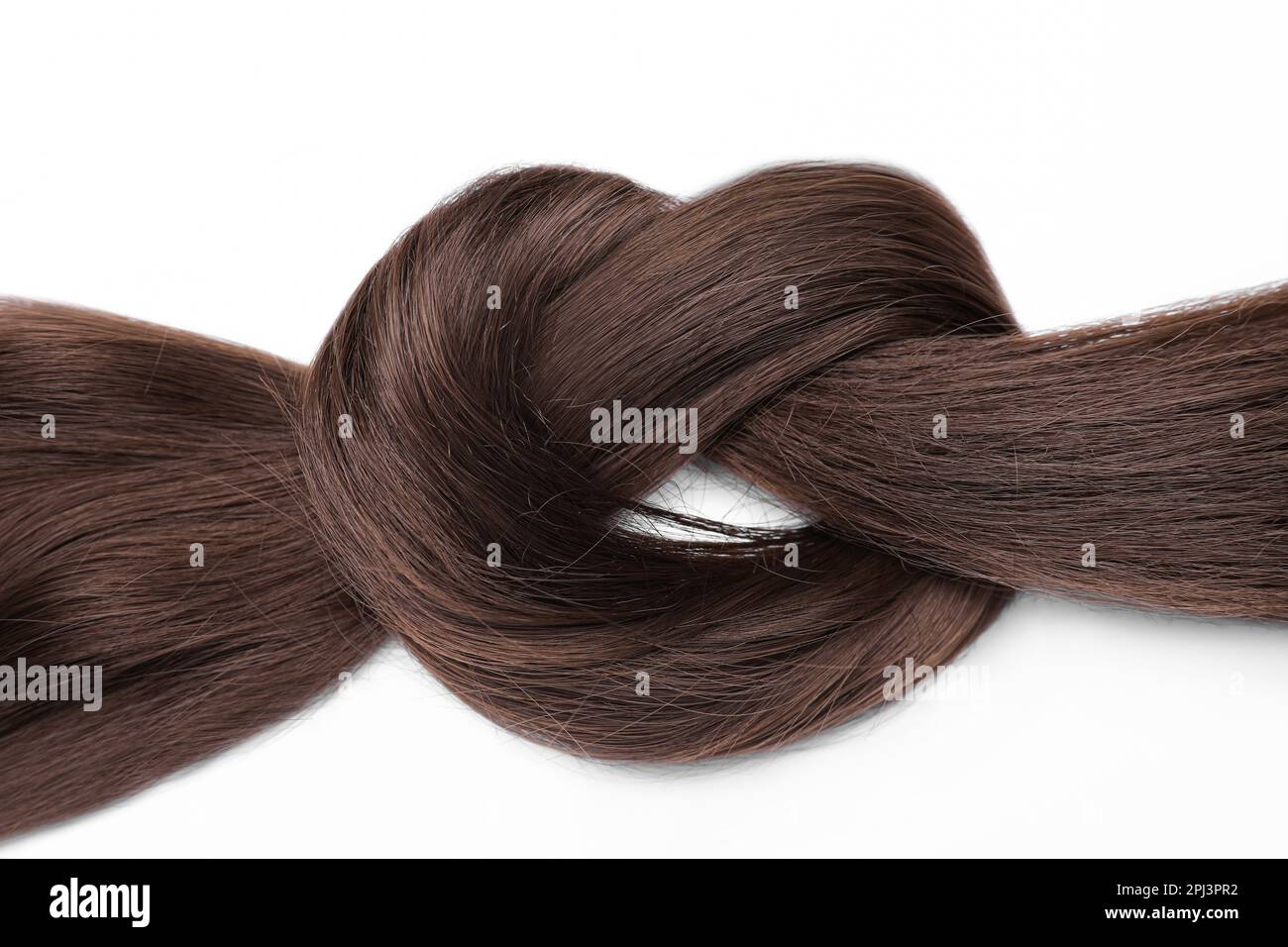 Beautiful strand of dark brown hair tied in knot on white background ...