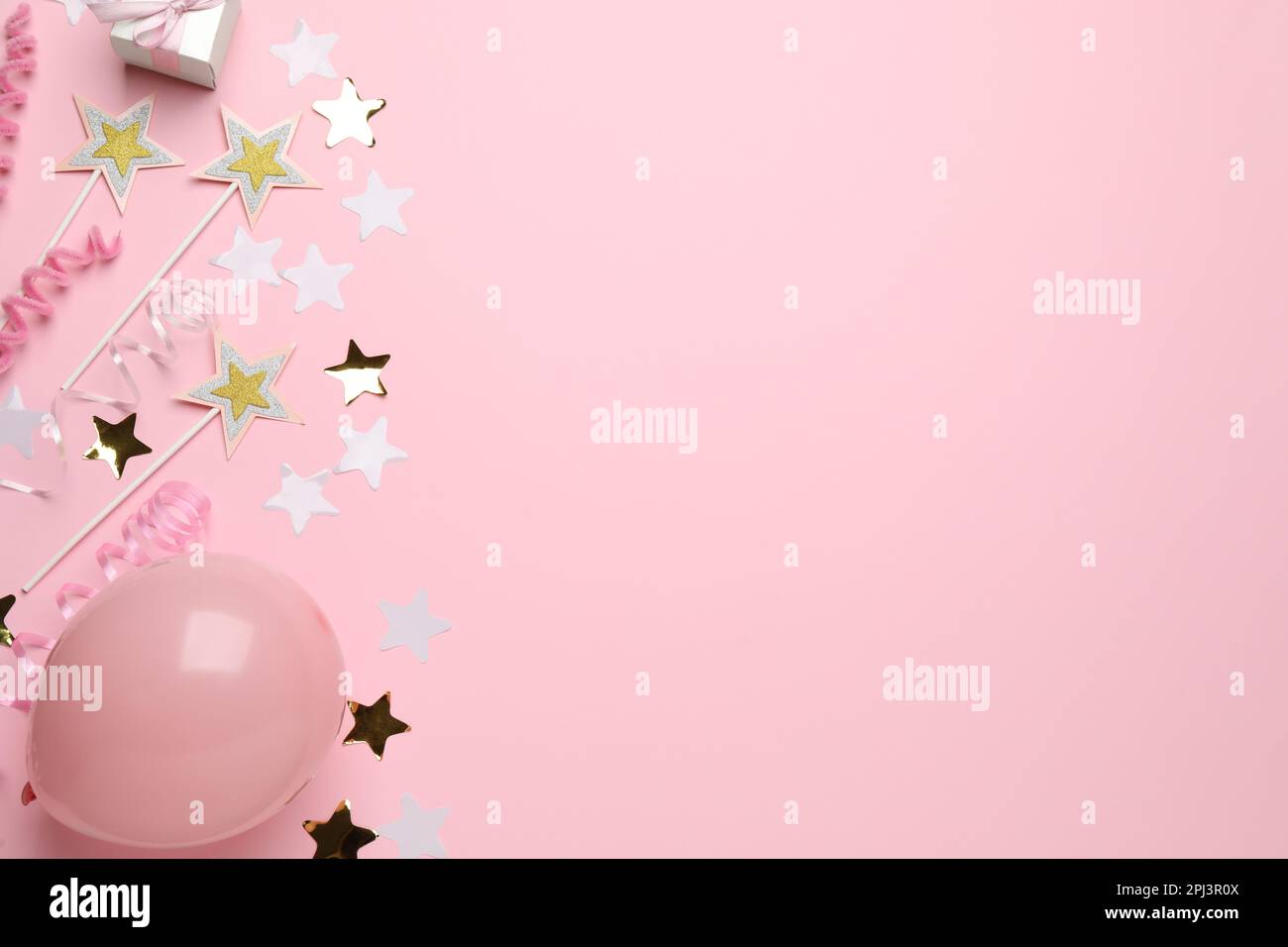 Flat lay composition with confetti and other party accessories on pink ...