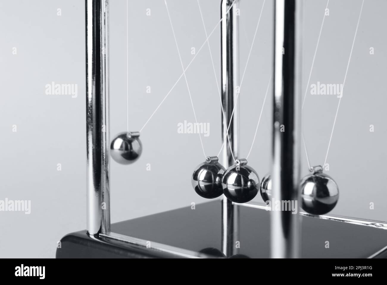 Newton's cradle on light background, closeup. Physics law of energy ...