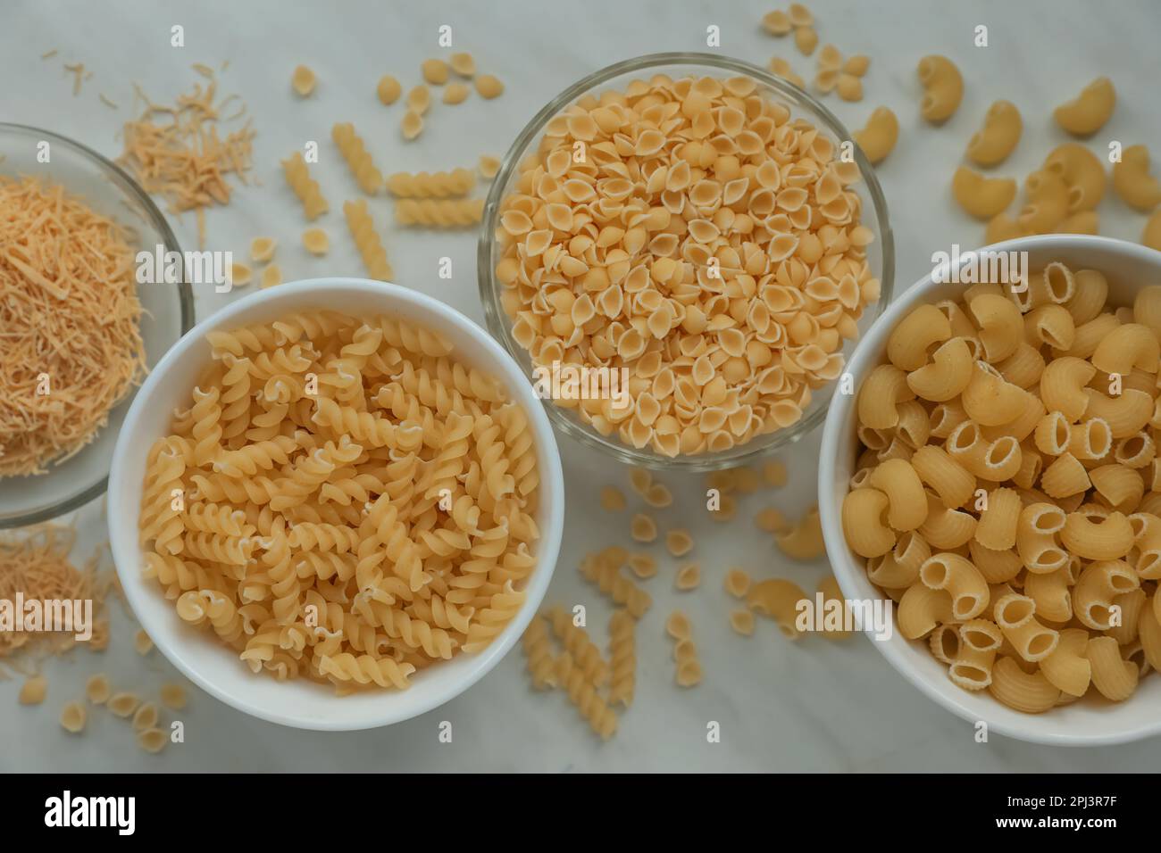 Different types of pasta on white marble table, flat lay Stock Photo ...