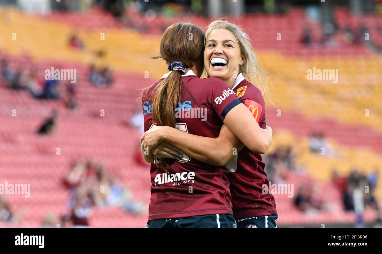 Sam Curtis (right) of the Reds celebrates scoring a try with Ellie ...