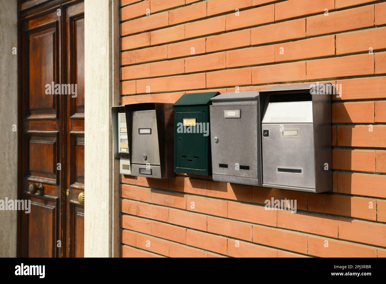 Many different mailboxes on red brick wall of building Stock Photo - Alamy