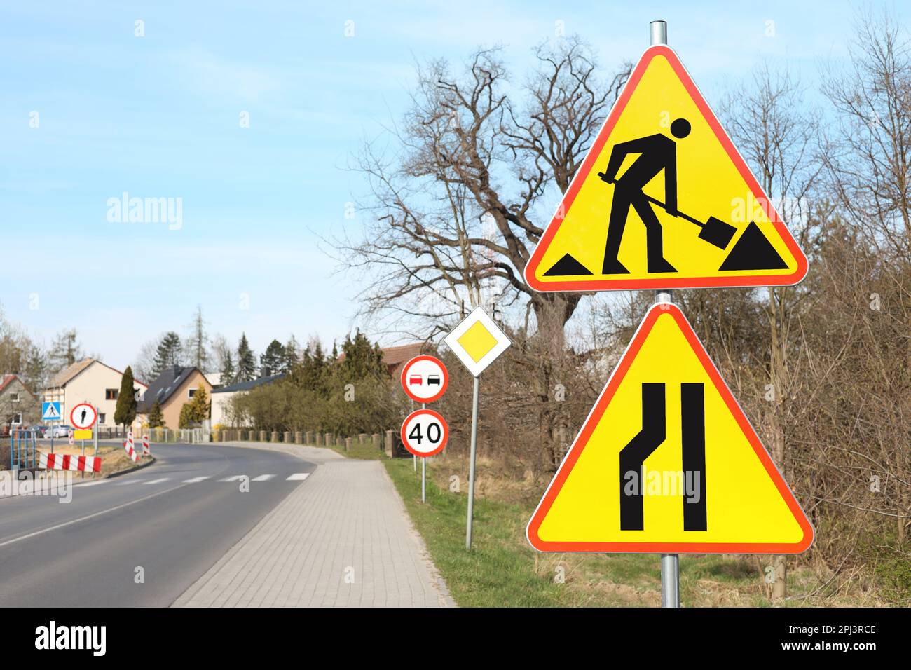 Different traffic signs on city street, space for text Stock Photo - Alamy