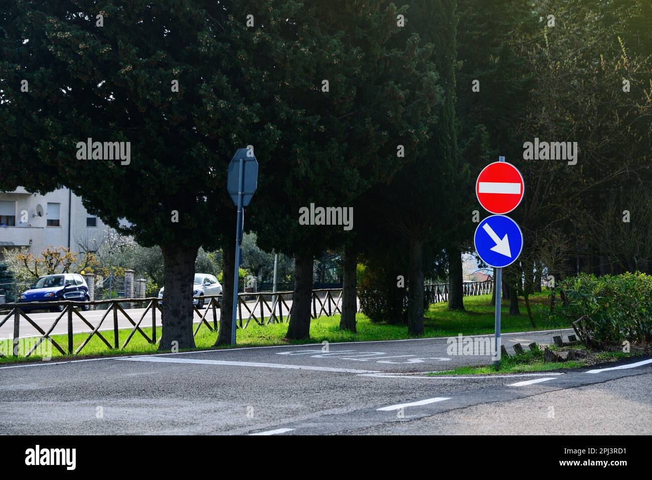 Post with traffic signs on city road Stock Photo - Alamy