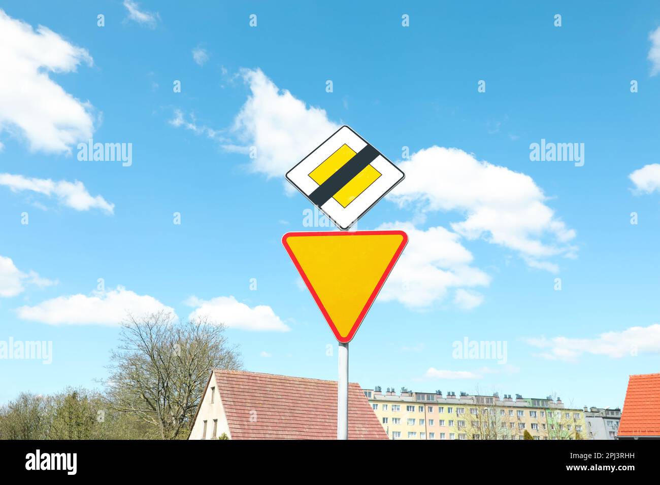 Traffic signs End Of Priority Road and Yield on city street Stock Photo ...