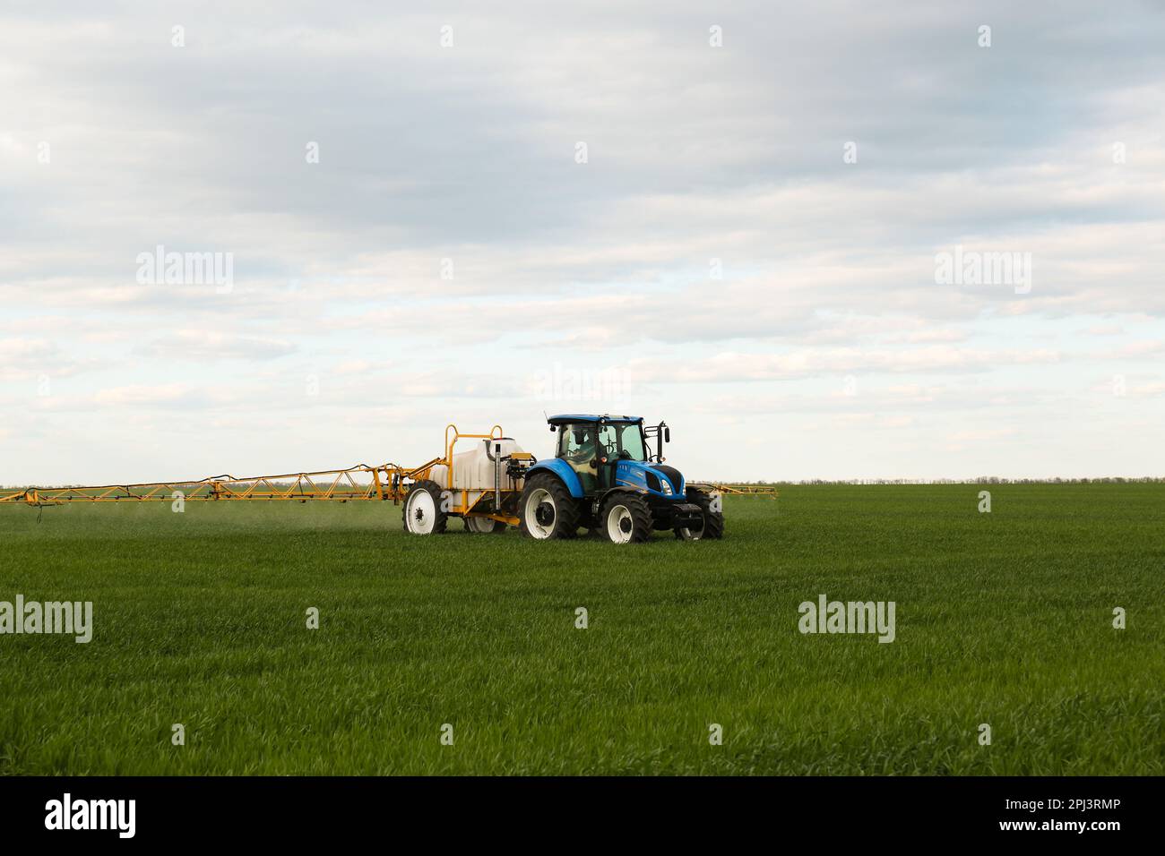 Tractor spraying pesticide in hi-res stock photography and images - Alamy