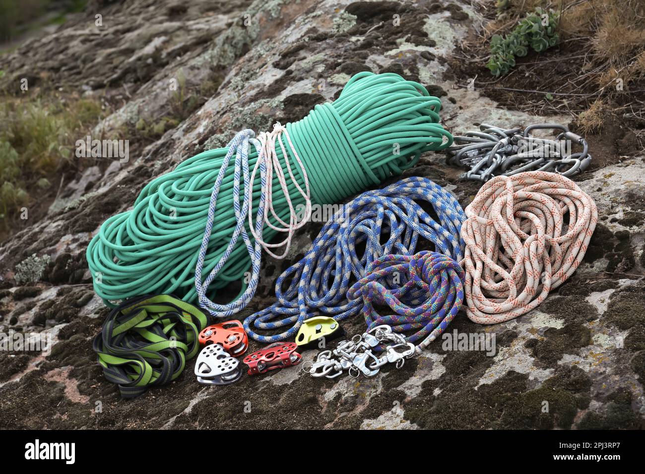 Different ropes and other climbing equipment on rock outdoors Stock ...