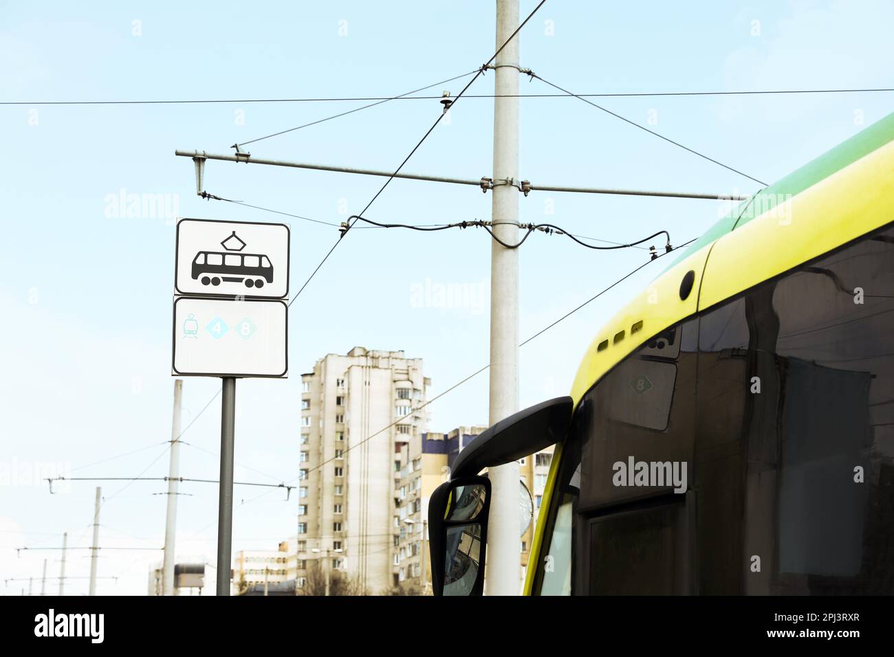 Modern streetcar near tram stop sign outdoors Stock Photo - Alamy