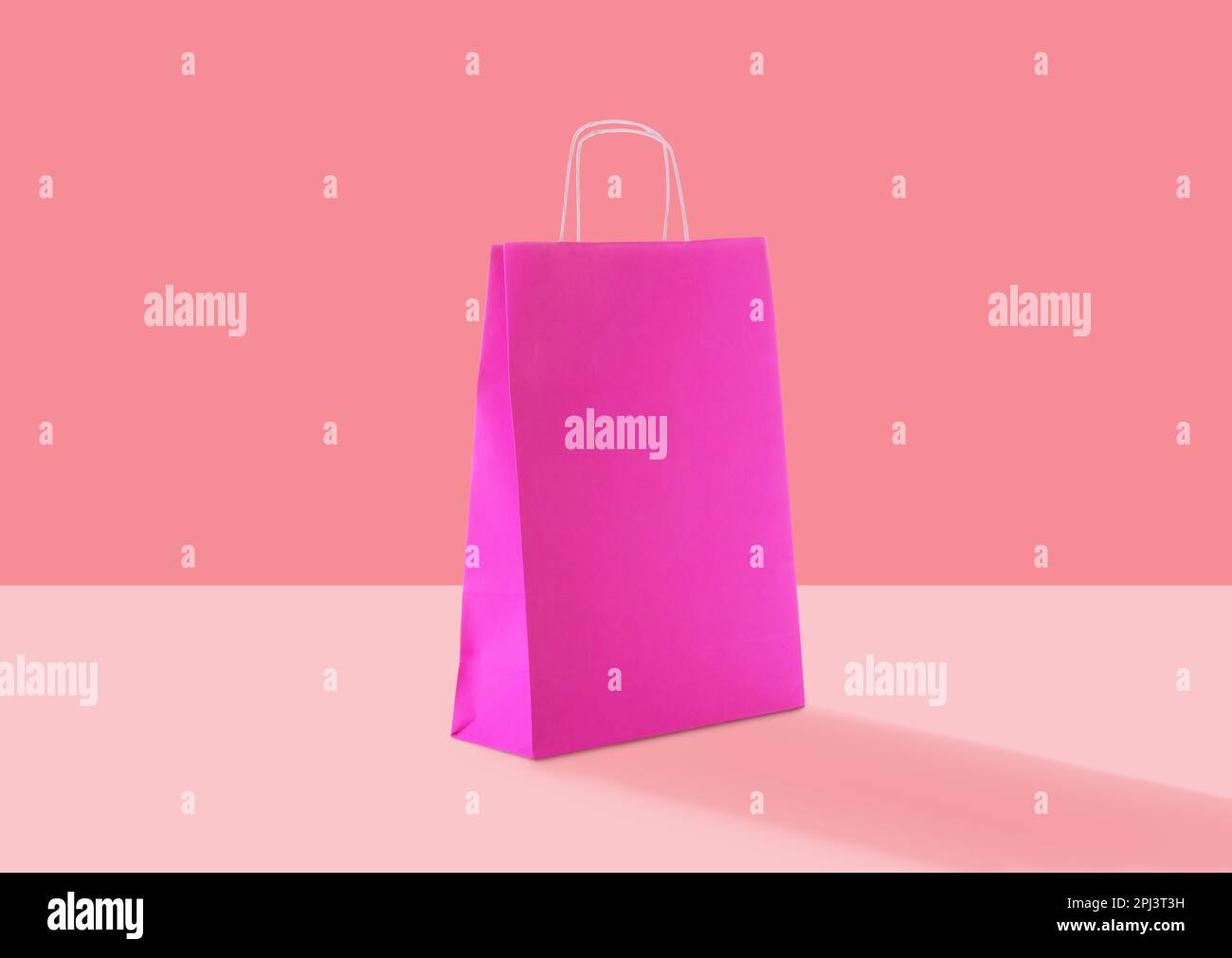 Pink paper bag on color background. Mockup for design Stock Photo - Alamy