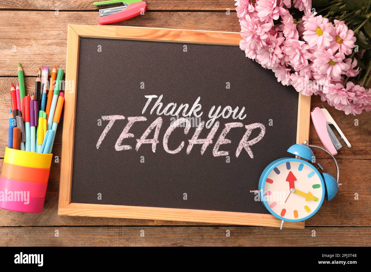 Small blackboard with phrase Thank You Teacher, flowers, alarm clock ...