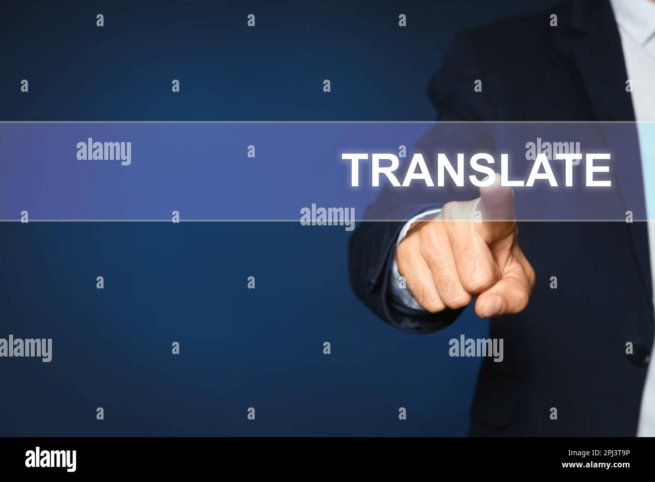 Man pointing at virtual model of word TRANSLATE against dark blue ...
