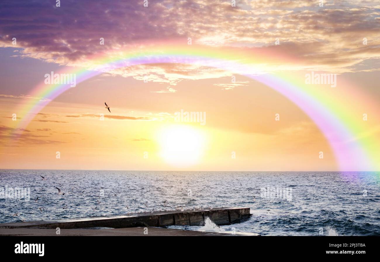 Beautiful view of colorful rainbow in sky over sea Stock Photo - Alamy