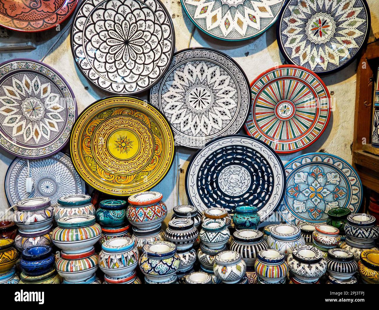 Handmade colourful decorated bowls or cups on display at traditional ...