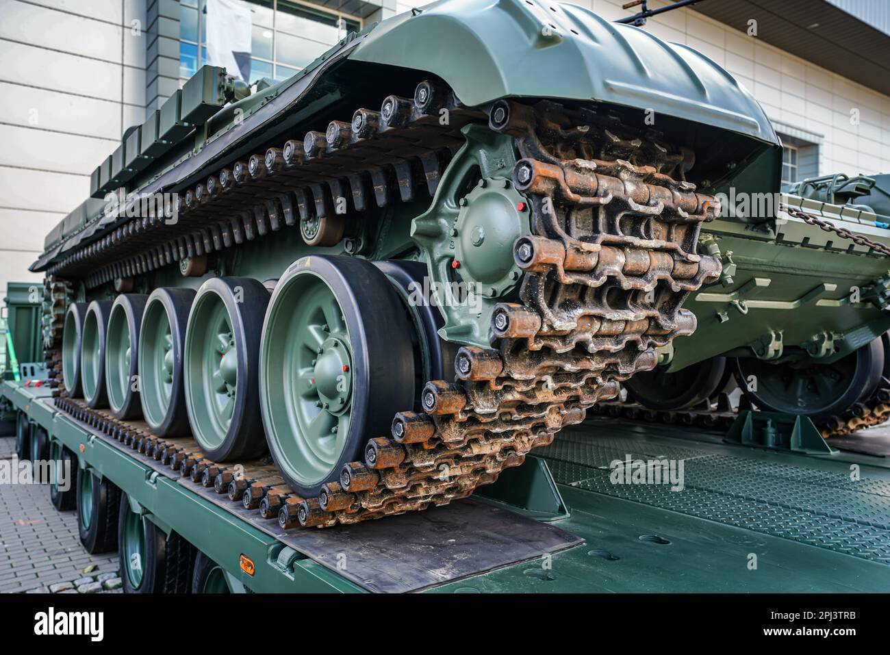 Tank armoured vehicle loaded on truck, detail to continuous tread ...
