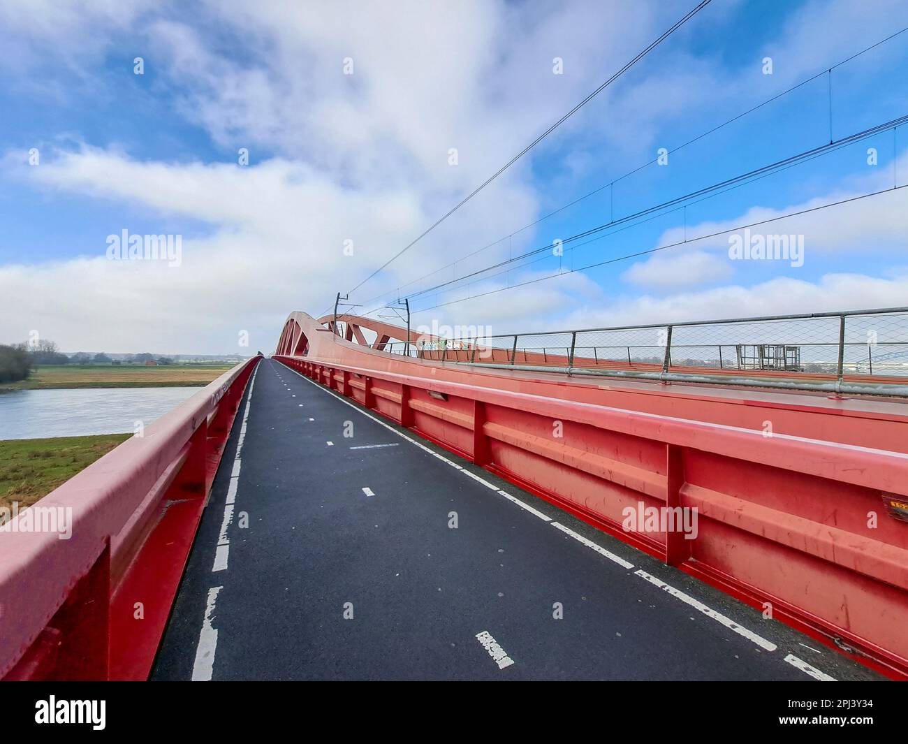 Red steel bridge called Hanzeboog over the river IJssel between Hattem ...