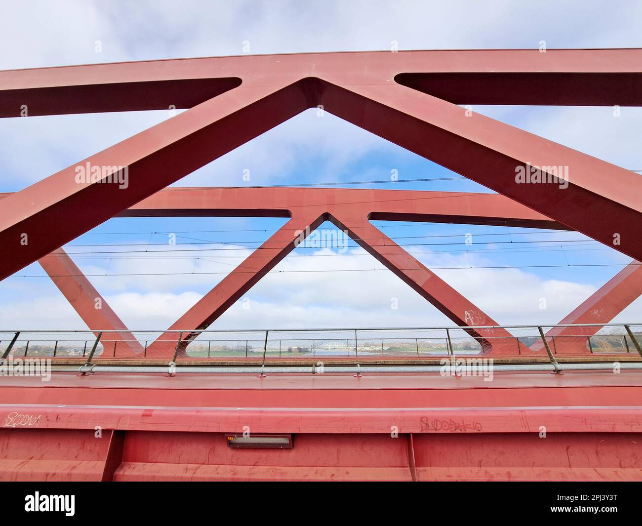 Red steel bridge called Hanzeboog over the river IJssel between Hattem ...