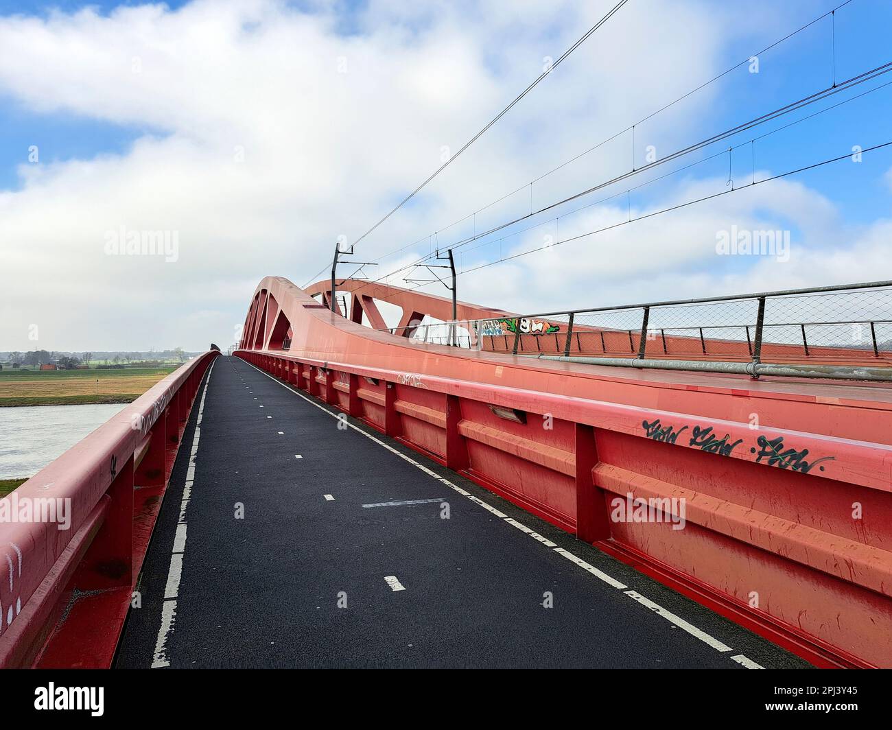 Red steel bridge called Hanzeboog over the river IJssel between Hattem ...
