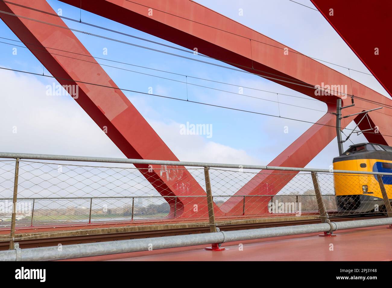Red steel bridge called Hanzeboog over the river IJssel between Hattem ...