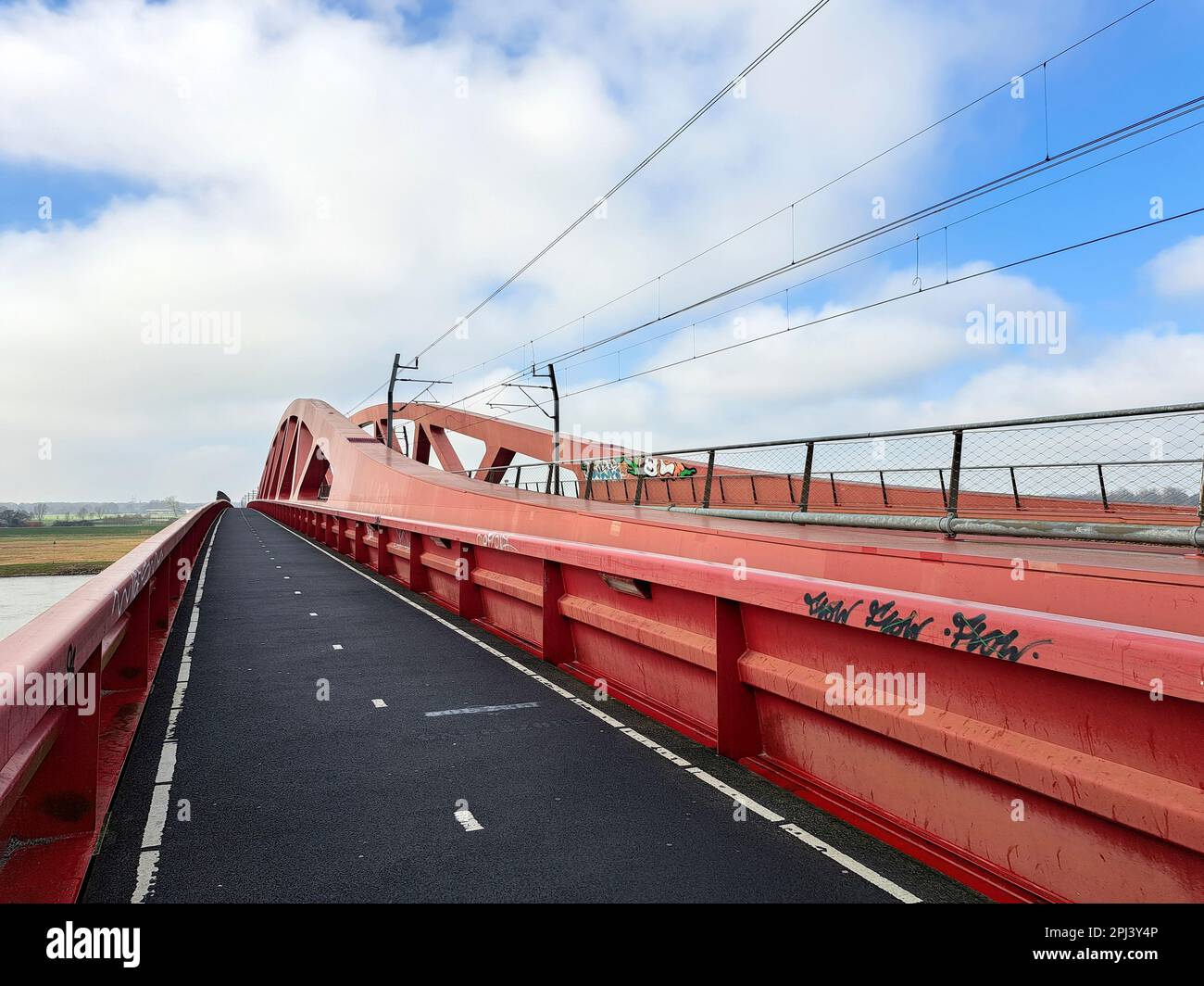 Red steel bridge called Hanzeboog over the river IJssel between Hattem ...