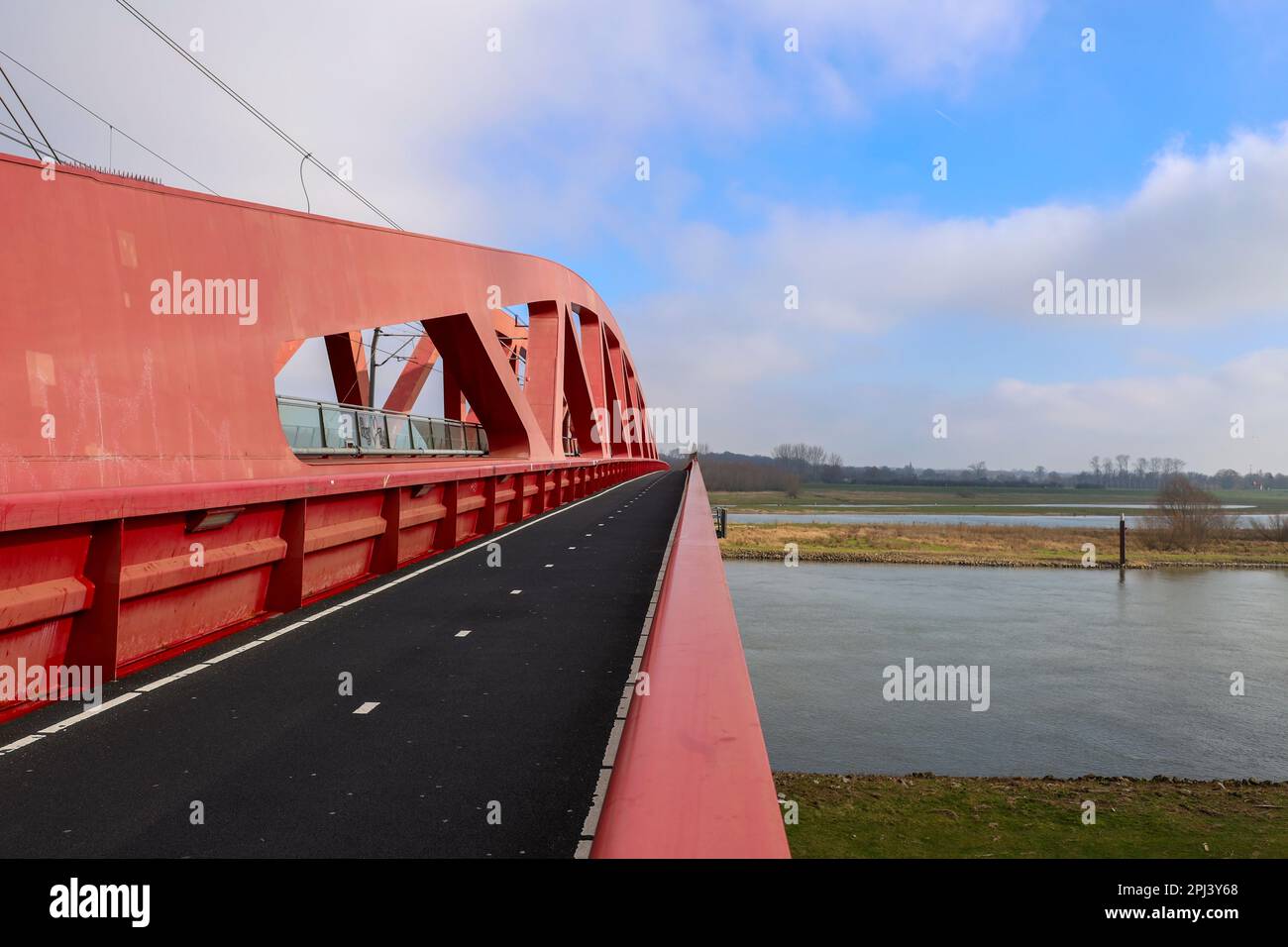 Red steel bridge called Hanzeboog over the river IJssel between Hattem ...