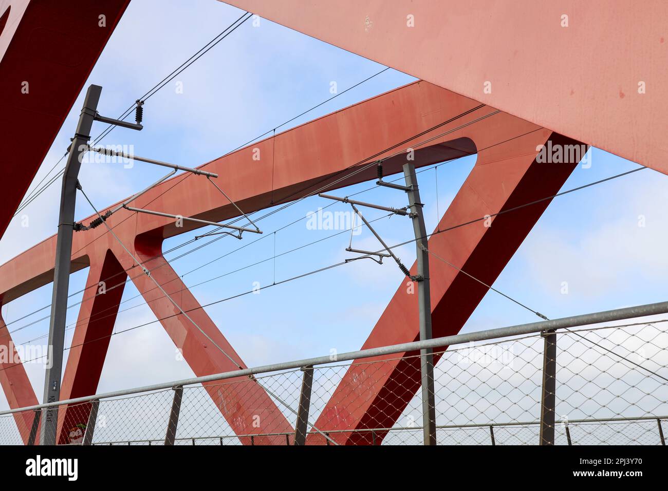 Red steel bridge called Hanzeboog over the river IJssel between Hattem ...