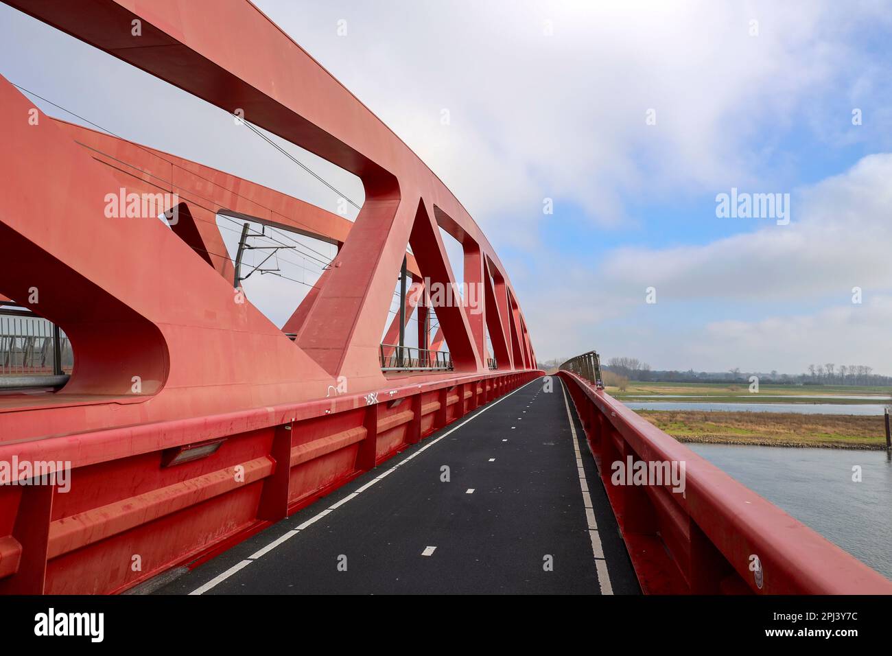Red steel bridge called Hanzeboog over the river IJssel between Hattem ...