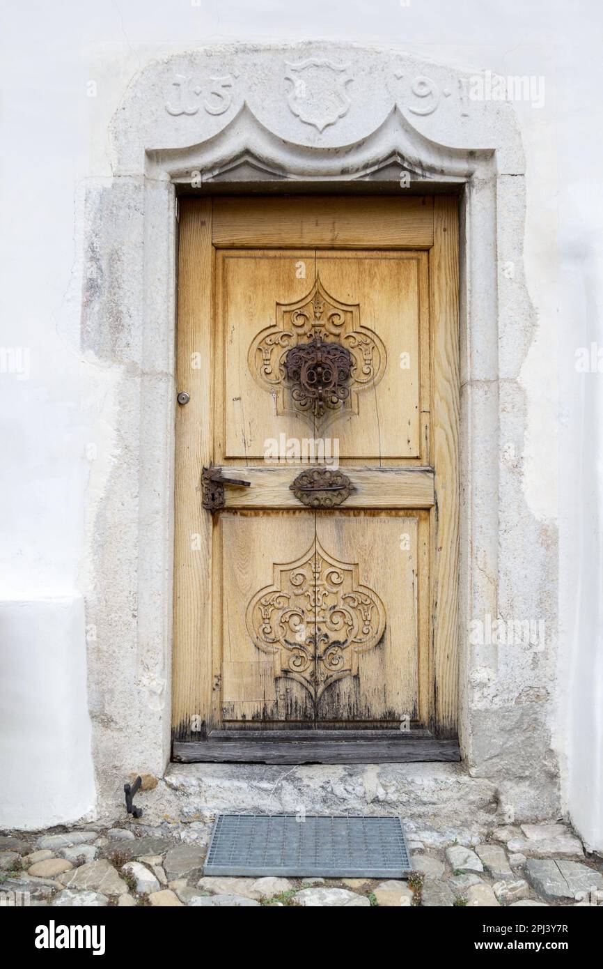 Traditional wooden door with carving pattern in the rural area of Alps ...