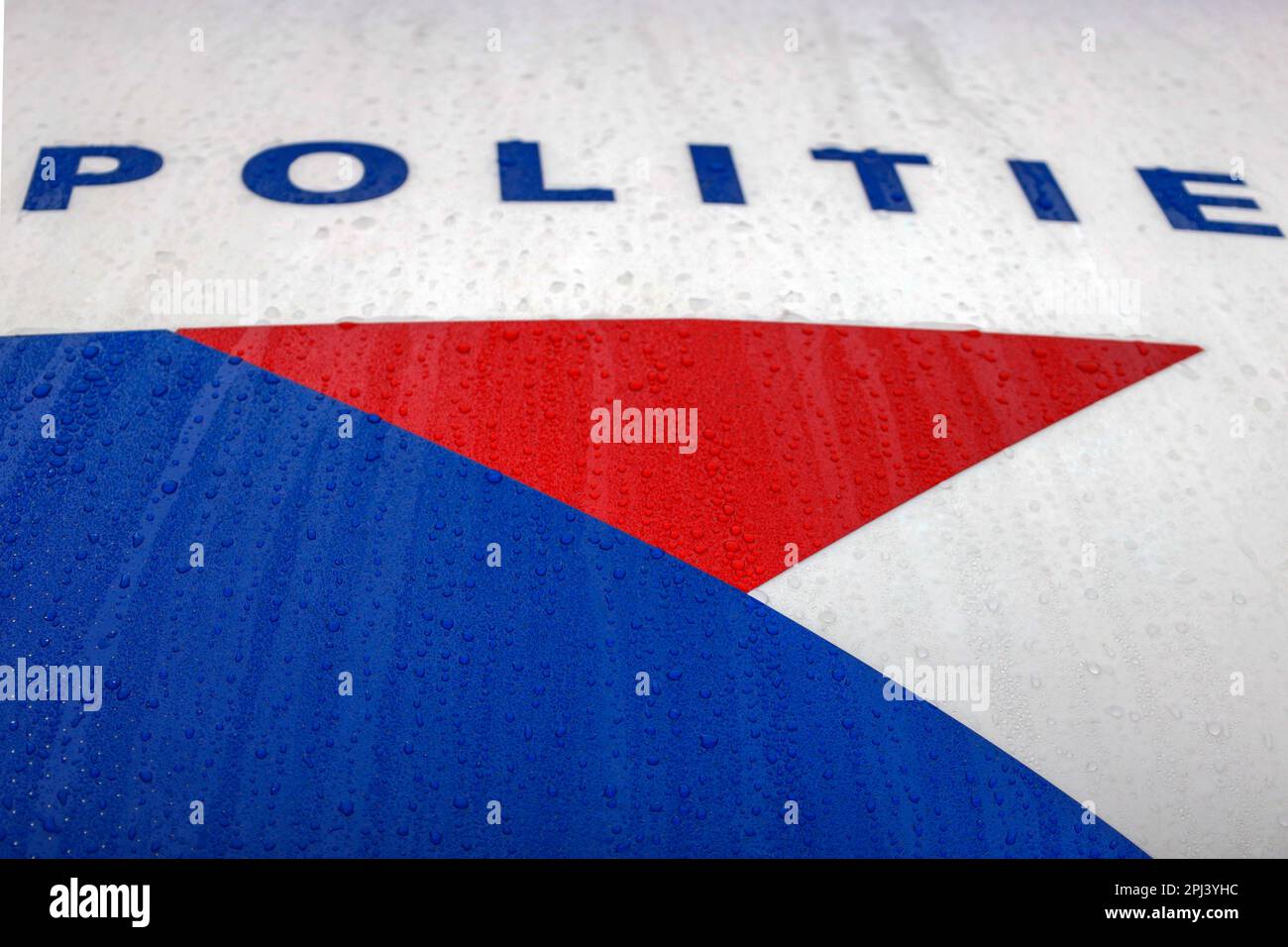 Logo and striping in front of dutch police (politie) car in the ...