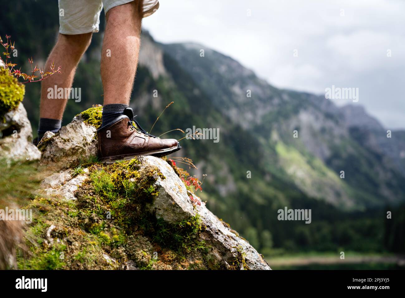 Adventure man hiking wilderness mountain with backpack Stock Photo - Alamy