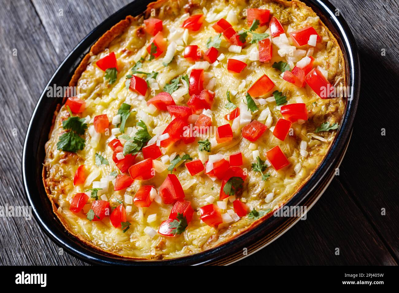 Green Chile Enchilada Casserole of corn tortillas layered with refried ...