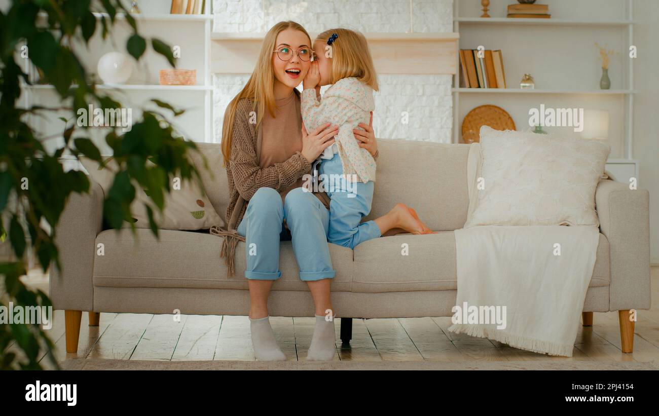 Caucasian family at living room. Woman mother babysitter listen secret ...