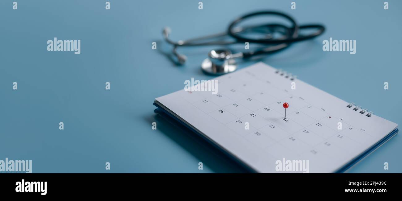 Black stethoscope,calendar on blue background, health care concept ...