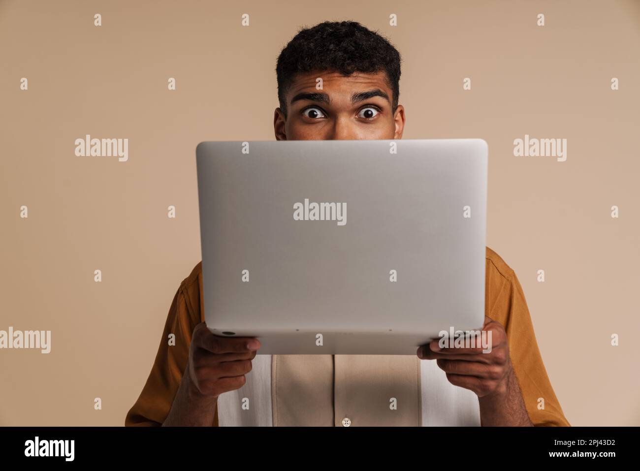 African man peeking out from hi-res stock photography and images - Alamy