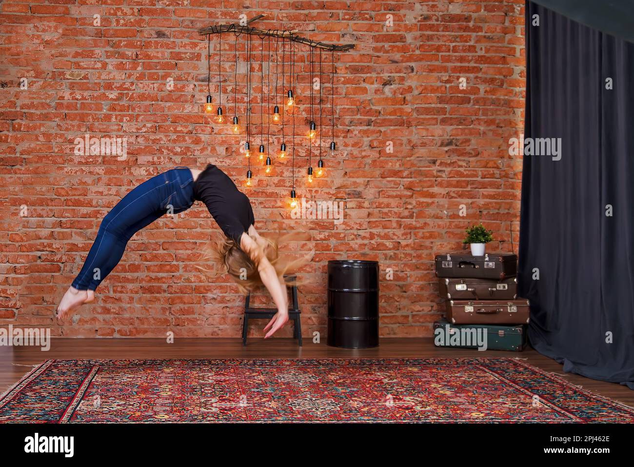 girl doing somersaults, body in the air, in the room Stock Photo - Alamy