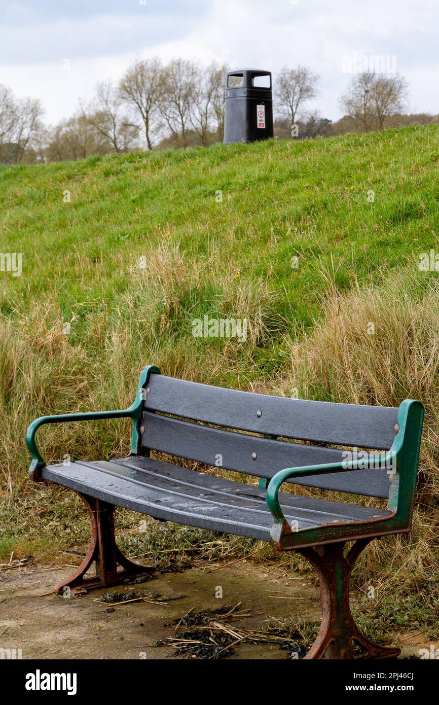 A bench and a litter bin near each other at the side of the River Deben ...