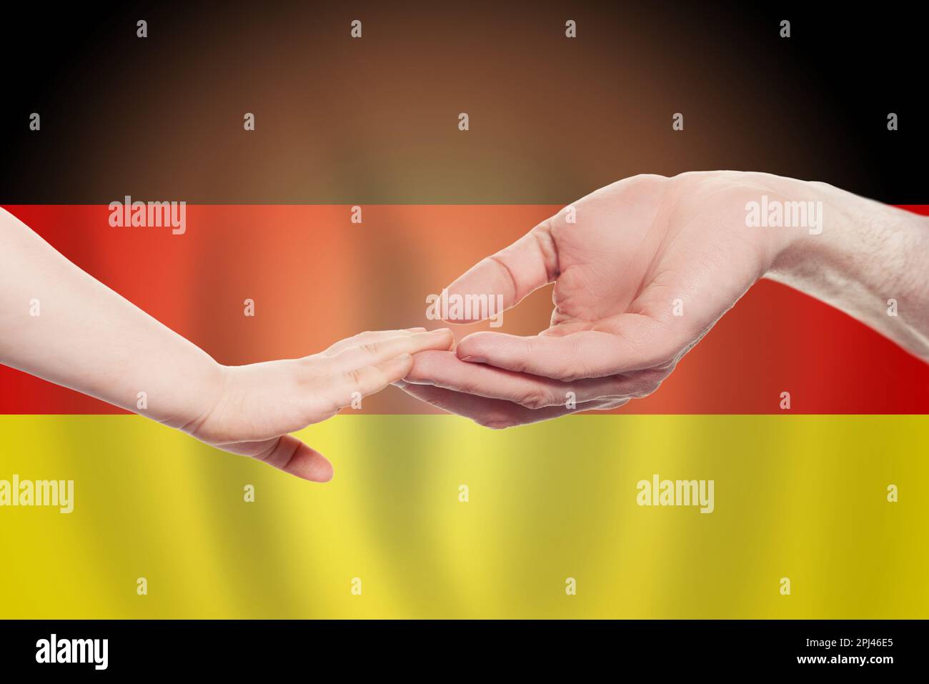 German baby and parent hands on the background of flag of Germany Help ...