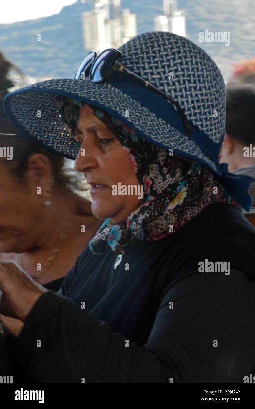 Turkey, Antalya, Lycia, Kas: bonneted Turkish lady at a pavement cafe ...