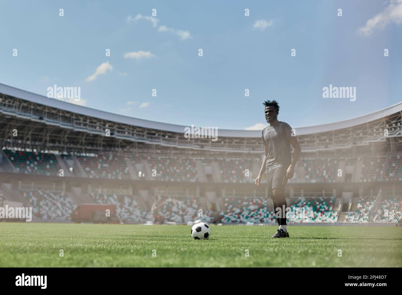 Professional male football, soccer player on stadium background ...