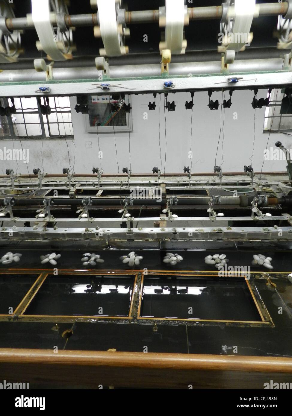 Drawing silk from silkworm cocoons hi-res stock photography and images ...