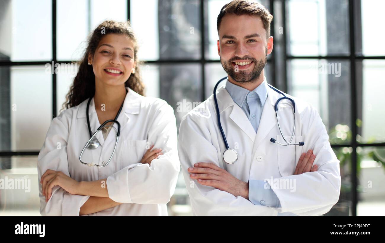 a female doctor and a male doctor are standing in the office with their ...
