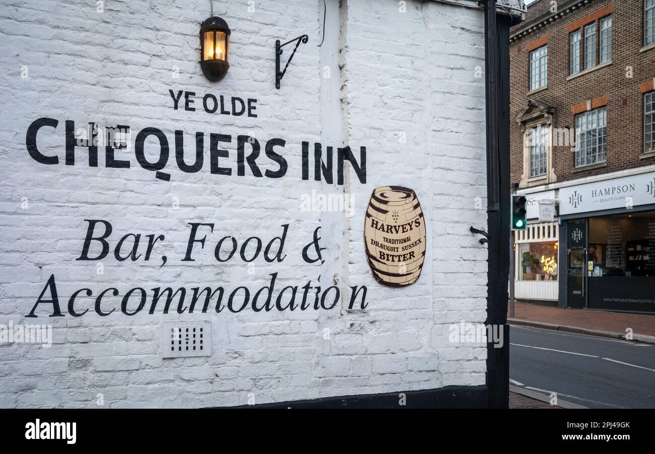 The name of the pub "Ye Olde Chequers Inn" hand painted on the side of ...
