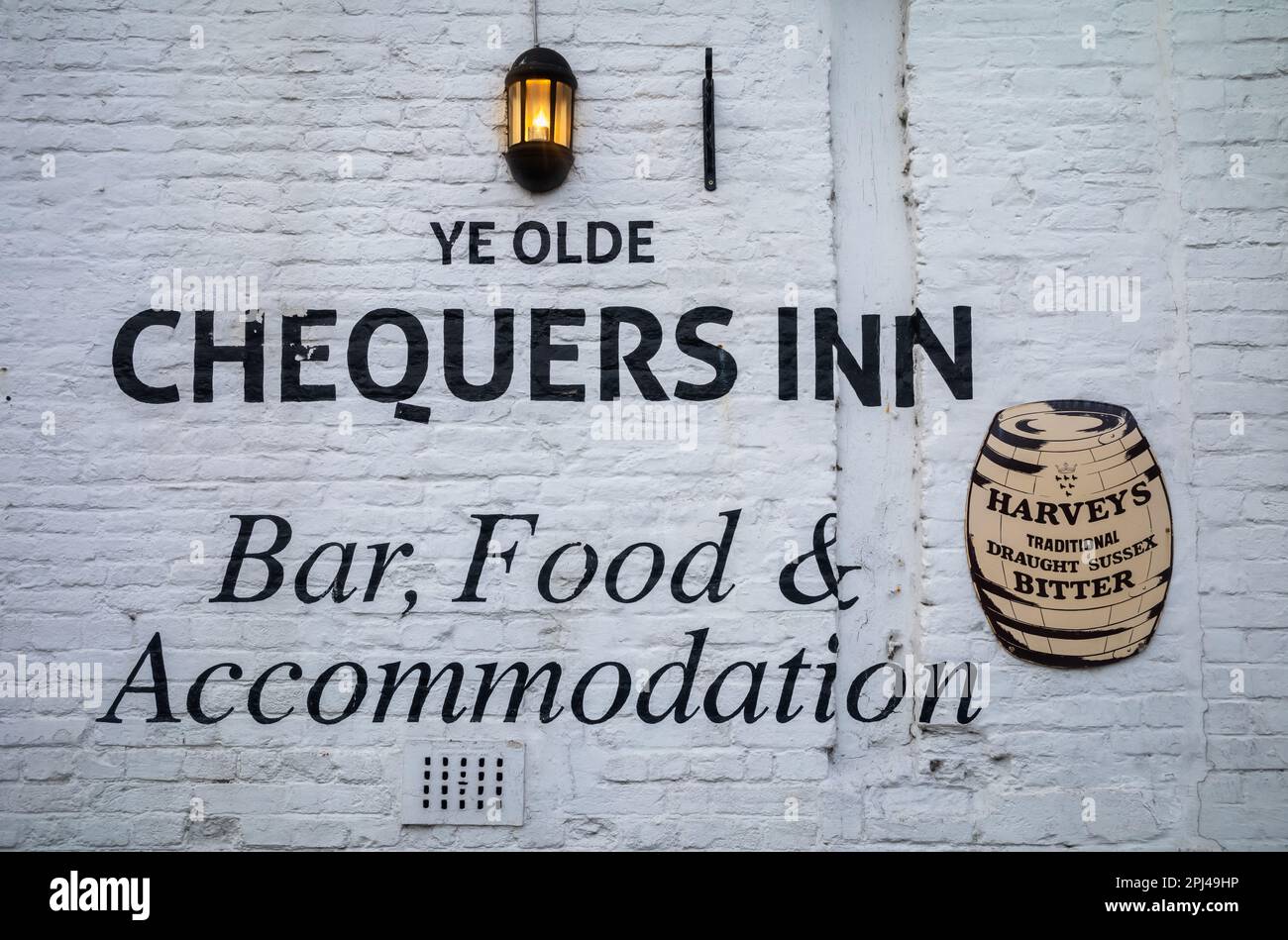 The name of the pub "Ye Olde Chequers Inn" hand painted on the side of ...