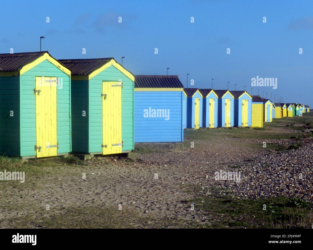 England, Sussex, Littlehampton: colourful bathing huts, stretching ...