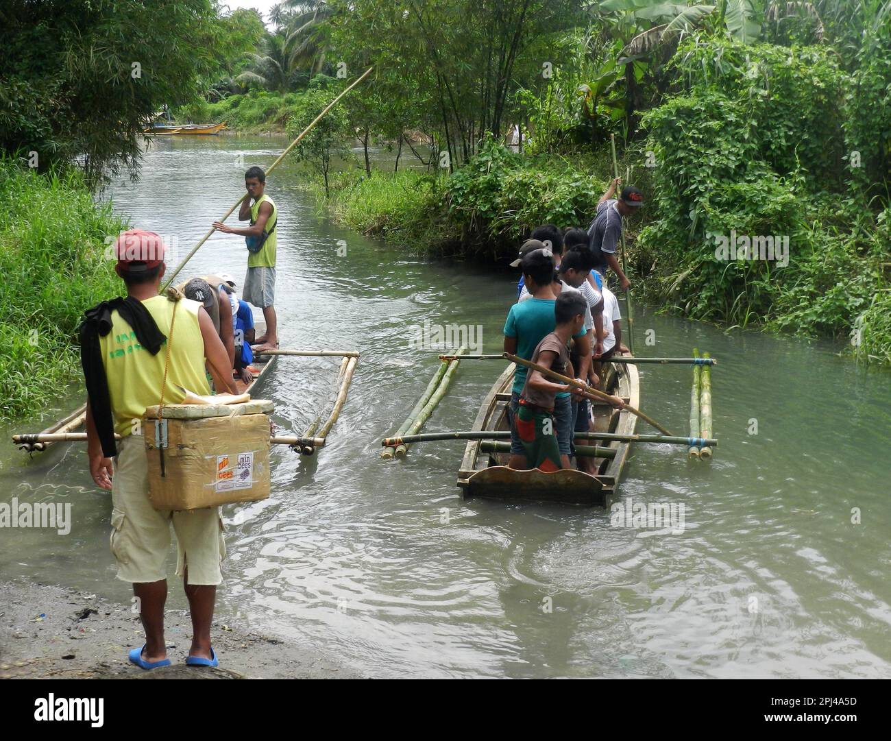 The Philippines, Samar Island: crossing a river to the neighbouring ...