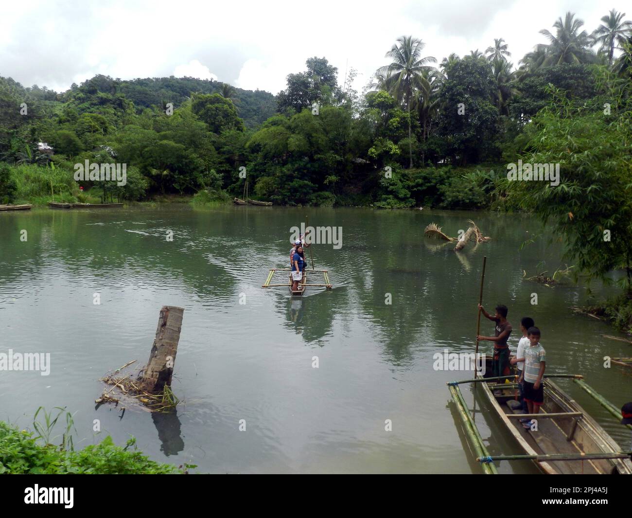 The Philippines, Samar Island: crossing a river to the neighbouring ...